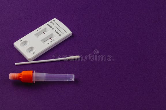 COVID-19 Testing Kit with Sample Collection Swab on Purple Surface ...