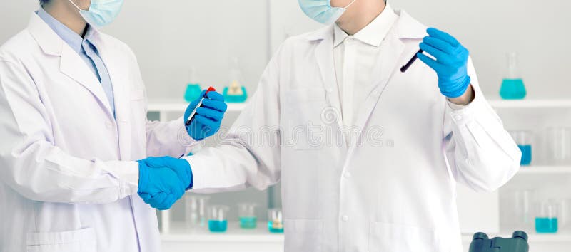Covid-19 Testing in Laboratory. Two Scientists Hand Shake while Holding ...