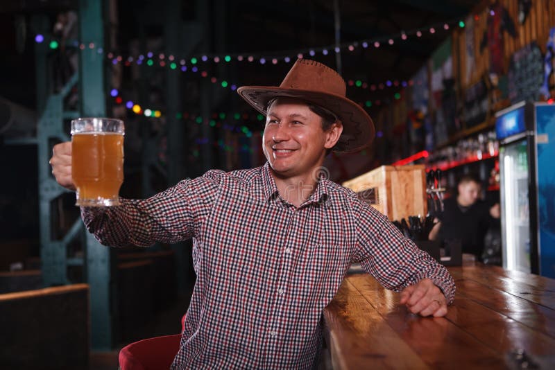 Cowboy Drinking Beer at the Saloon Stock Photo - Image of west, cowboy ...