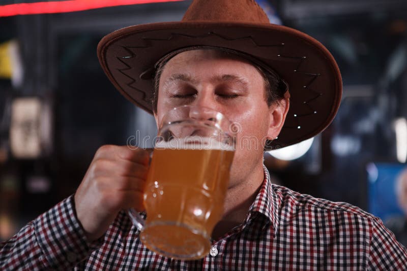 Cowboy Drinking Beer at the Saloon Stock Image - Image of saloon ...