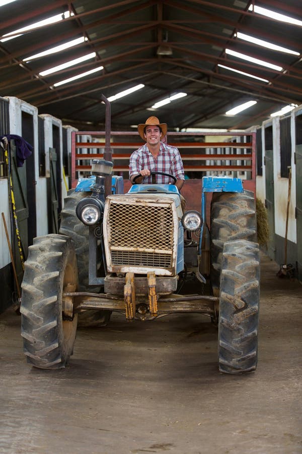 Cowboy driving tractor stock image. Image of looking - 43034639