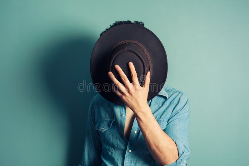 Cowboy Hiding Behind His Hat Stock Image - Image of attractive, happy ...