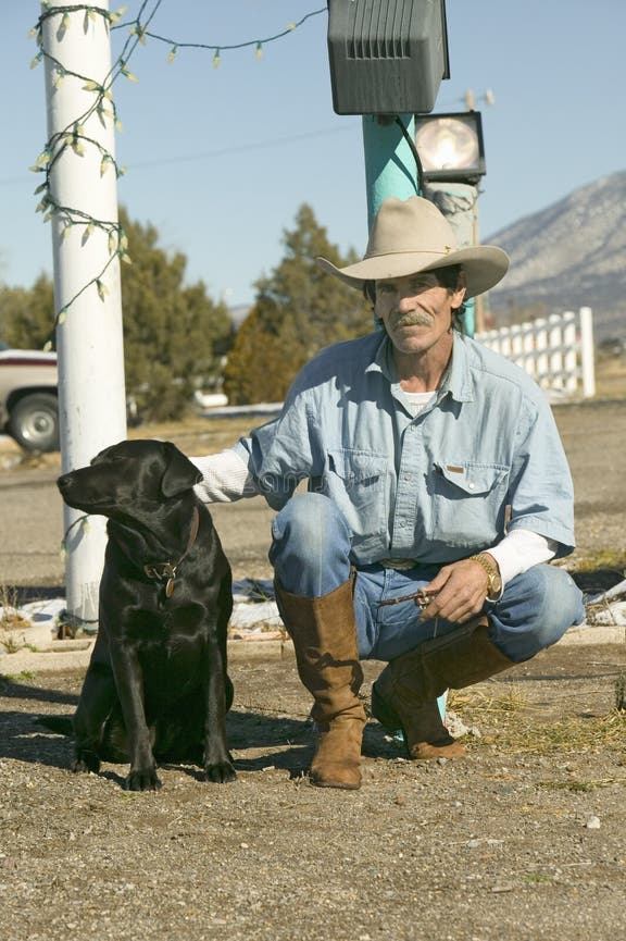 Cowboy with his dog editorial photography. Image of aged - 23180362