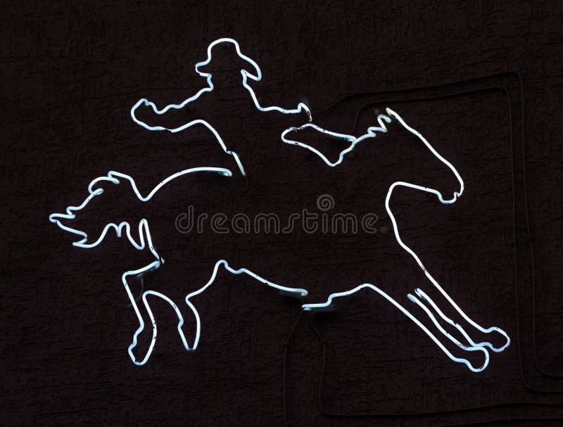 Neon Cowboy Lights Glowing on the Wall Rider Leather Saddles Stock ...