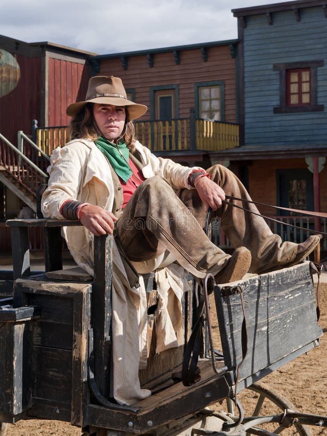 Cowboy sitting on a wagon stock photo. Image of copy - 19407414
