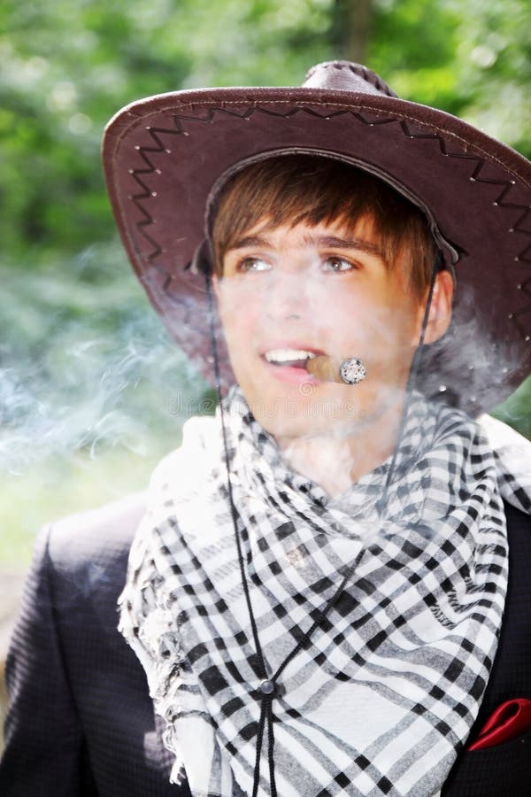 Cowboy smoking a cigar stock image. Image of outdoors - 45192525