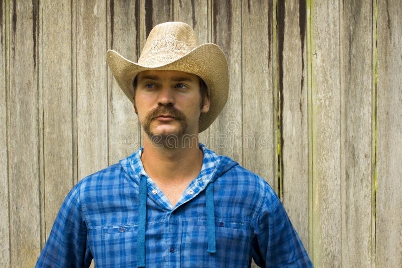 Cowboy with Straw in His Mouth Stock Photo - Image of hand, vertical ...