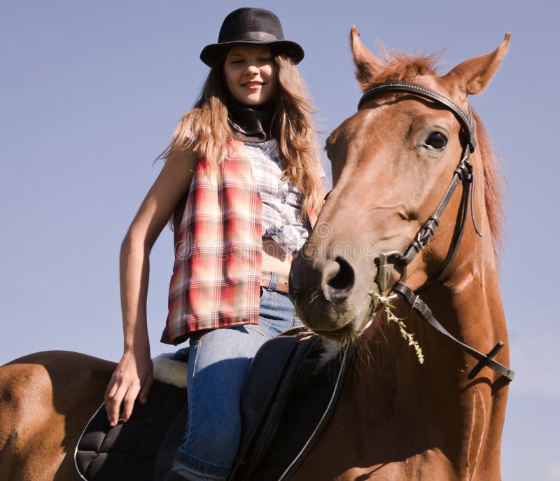 Cowgirl riding a bay horse stock image. Image of attractive - 26494279