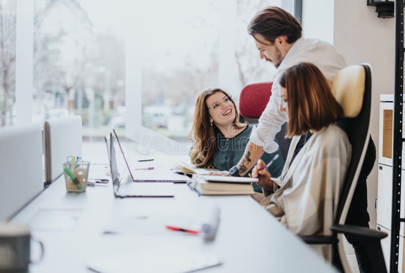 Young Employees Collaborating in a Modern Office. Discussing Project ...