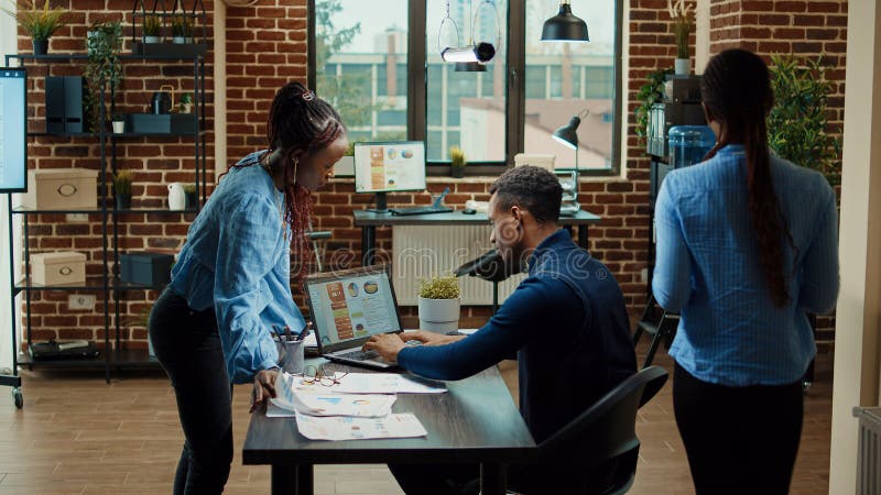Coworkers Discussing about Reports Plan Stock Photo - Image of people ...