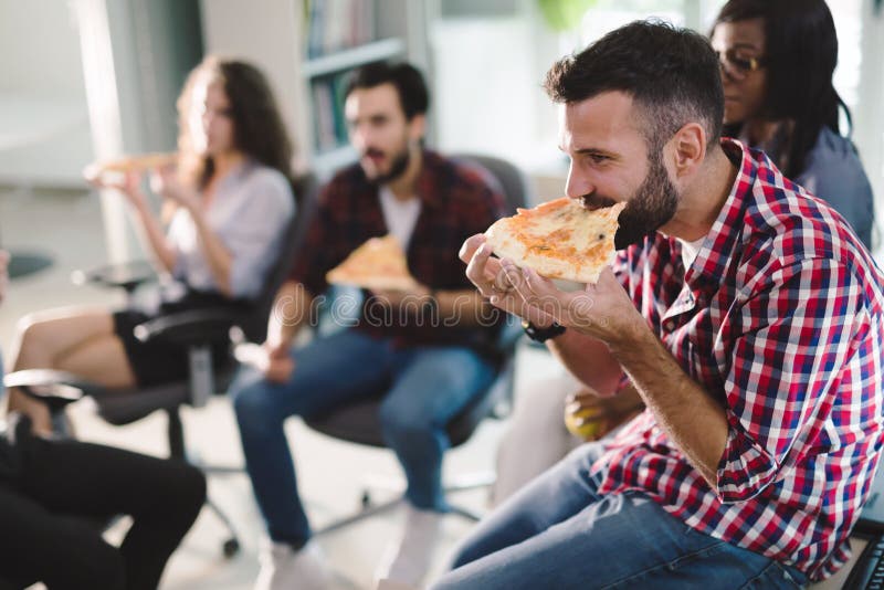 Coworkers Eating Pizza during Break at Office Stock Image - Image of ...