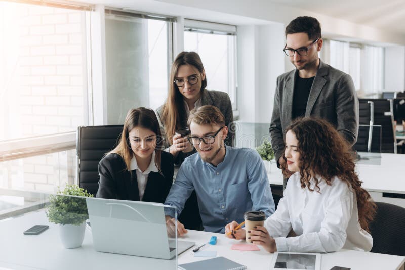 Coworkers Looking at a Computer and Talking about Work Stock Photo ...