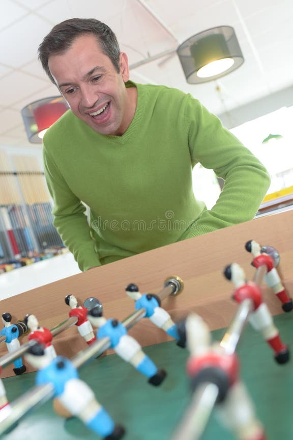 Coworkers Playing Foosball Table in Office Stock Image - Image of ...