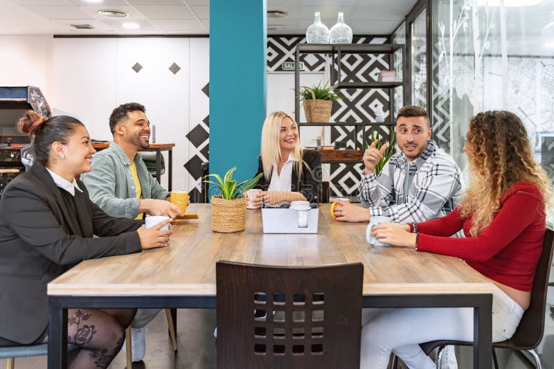 Coworkers Smiling and Talking while Having a Coffee Break in the Office ...