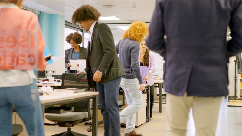 Coworkers Standing Up and Leaving the Office Stock Photo - Image of ...