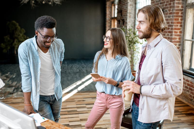 Coworkers Talking Together at the Office Stock Photo - Image of ...