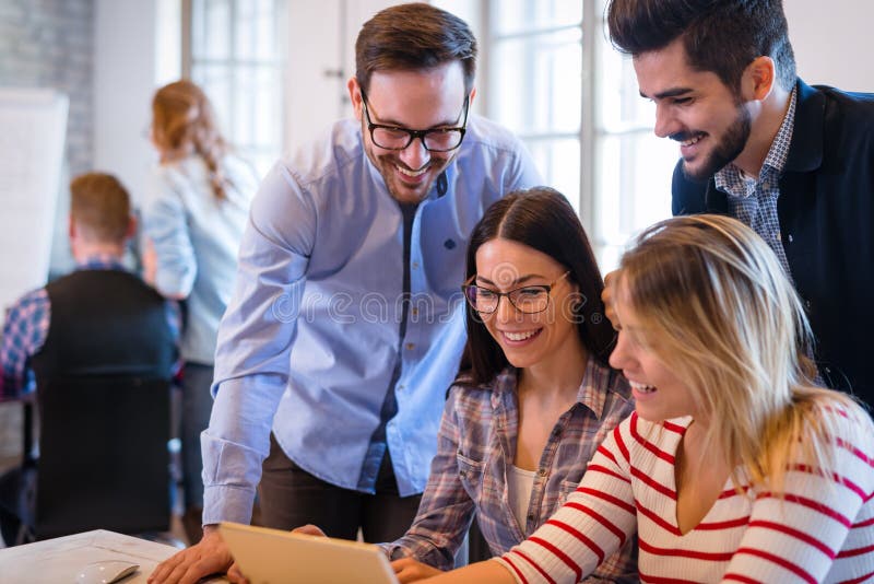 Coworkers Working on Project Together in Office Stock Photo - Image of ...