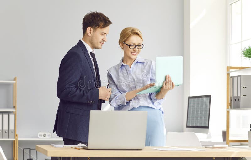 Coworkers Working Together with Laptop in Office Stock Photo - Image of ...