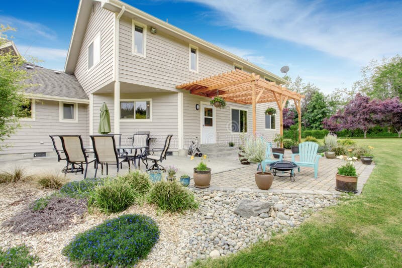 Cozy Backyard Patio Area with Table Set Stock Photo - Image of back ...