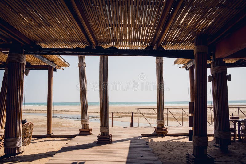 A Cozy Beach Cafe with Couch and Rustic Chairs Stock Photo - Image of ...