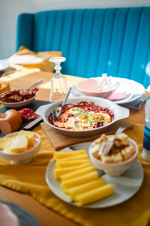 Cozy Breakfast Table with Delicious Cheesy Shakshuka and Assorted ...