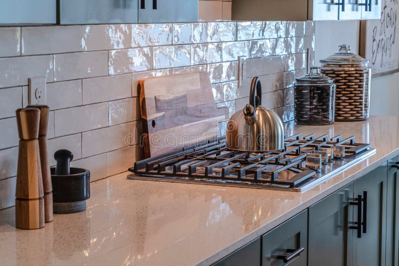Cozy and Clean Kitchen Interior with Cooktop and Cooking Tools on the ...