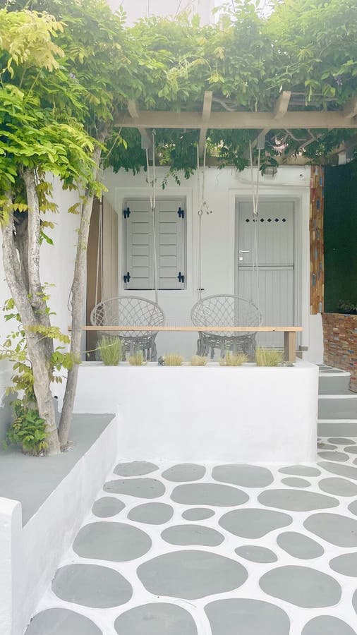 A Cozy Courtyard with Greenery in Cycladic Style, Painted Stone ...