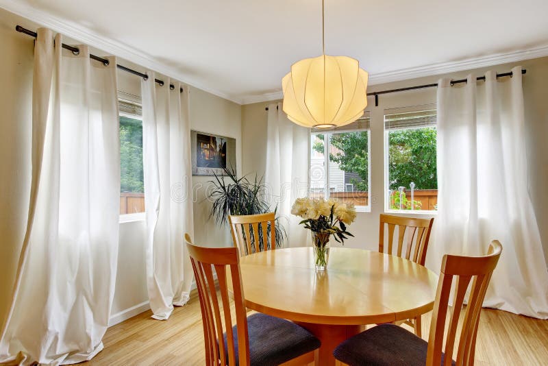 Cozy Dining Area with Table Set and Curtains in Creme Tones. Stock ...