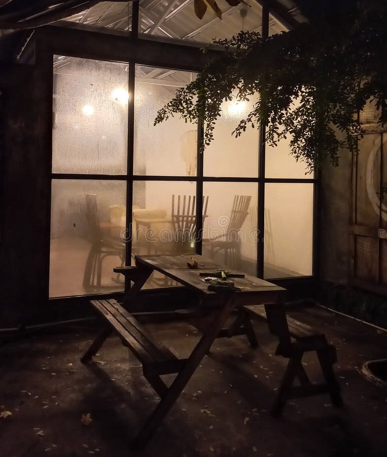 A Cozy Dinner Spot on a Dark Night with a View of the Dewy Glass Stock ...