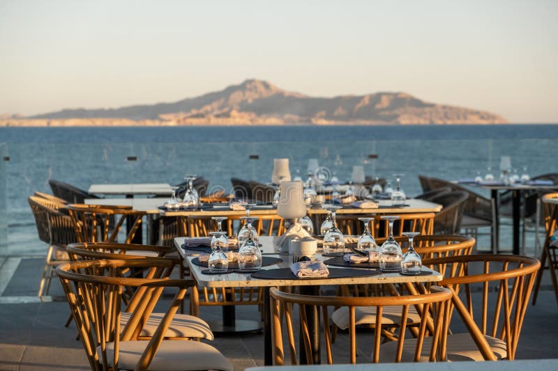 A Cozy yet Elegant Oceanfront Dining Experience, with Set Tables and ...