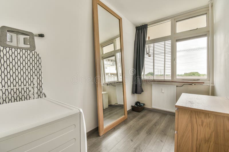 Cozy Laundy Room with Washing Machine and Ironing Board Stock Image ...