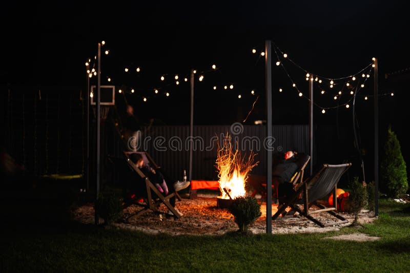 Cozy Outdoor Evening with Fire Pit and String Lights Stock Photo ...