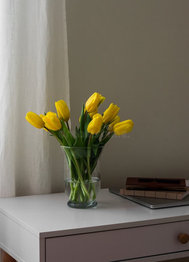 A Cozy Place - a Bouquet of Yellow Tulips, a Laptop, a Notebook on a ...