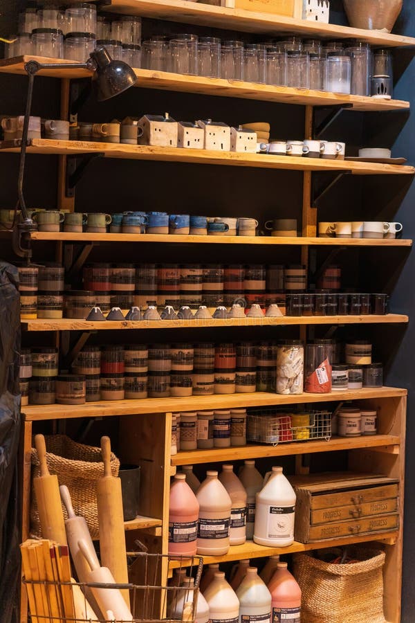 Cozy Pottery Studio with Ceramic Supplies and Mugs on Shelves Stock ...