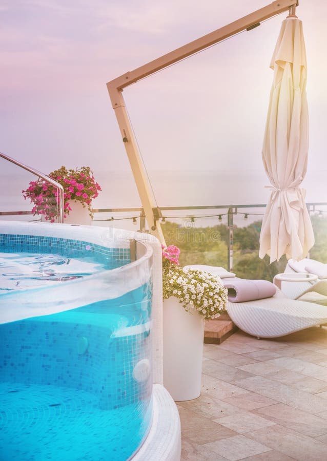 A Cozy Resting Place Near a Transparent Pool Overlooking the Sea. Stock ...