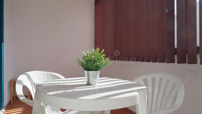 Cozy and Sunny Setting on the Covered Terrace with Table and Chairs and ...