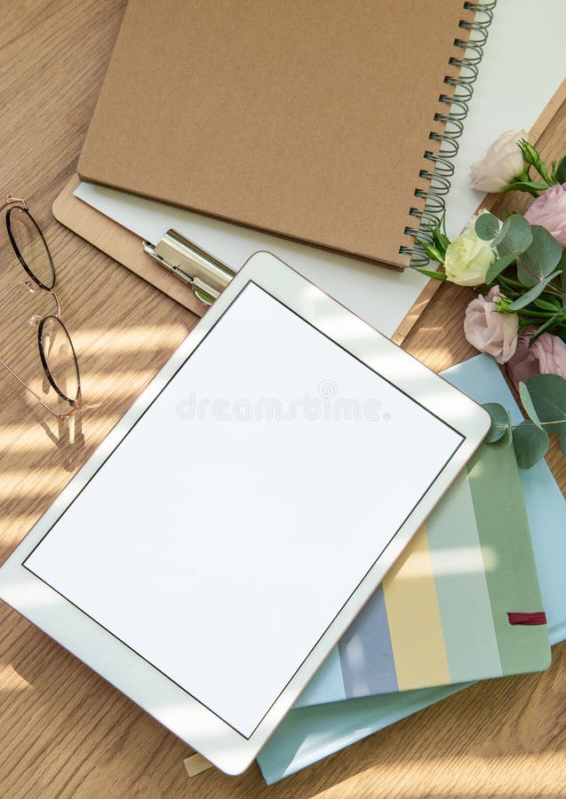 A Cozy Workspace Setup Featuring a Tablet, Stationery, and Fresh ...