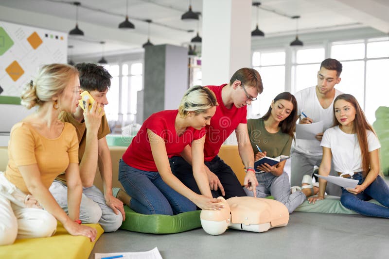 CPR Class with Caucasian Instructors Speaking and Demonstrating Help ...