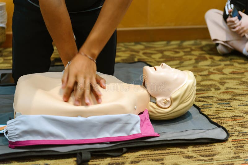 CPR First Aid Training with CPR Dummy in the Class. Demonstrating Chest ...