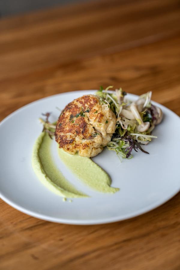 Crab Cake Appetizer with Garnish on a White Plate at a Fancy Restaurant ...