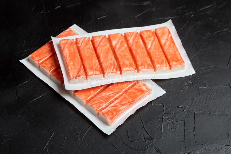 Crab Sticks or Imitation Crab Meat on Black Table Stock Image - Image ...