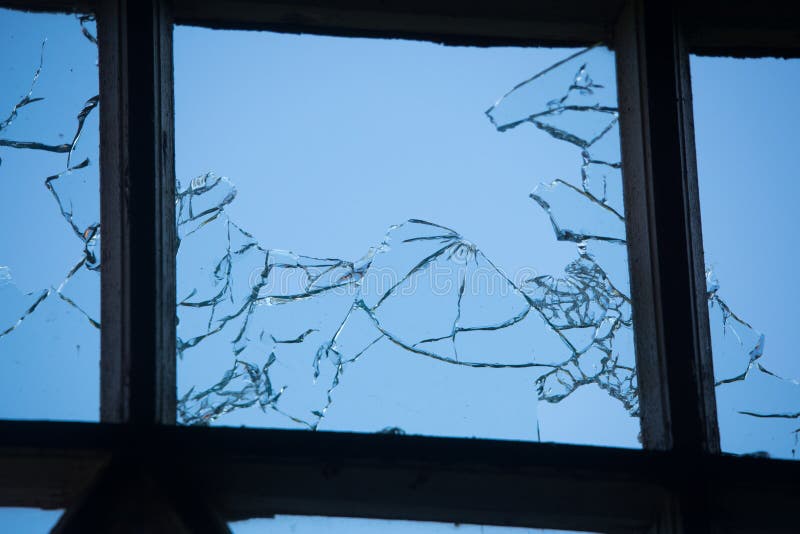 Cracked and Broken Window Glass Punched by a Pistol Bullet Stock Image ...