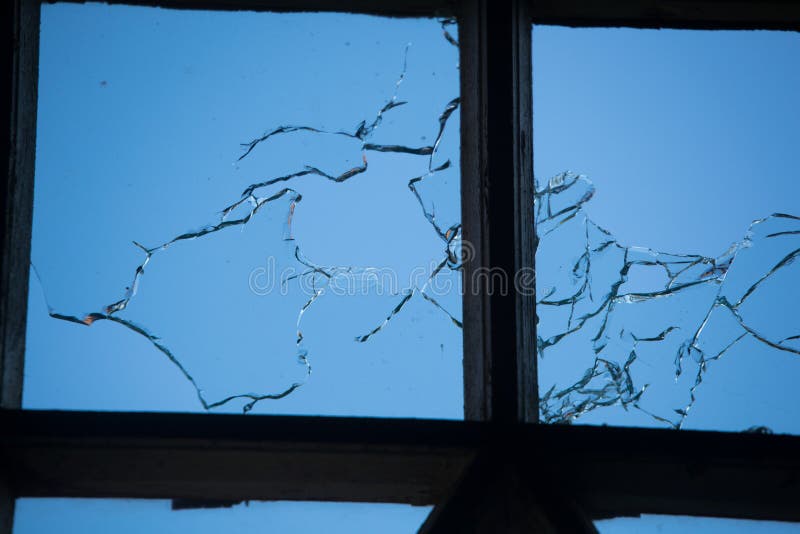 Cracked and Broken Window Glass Punched by a Pistol Bullet Stock Image ...