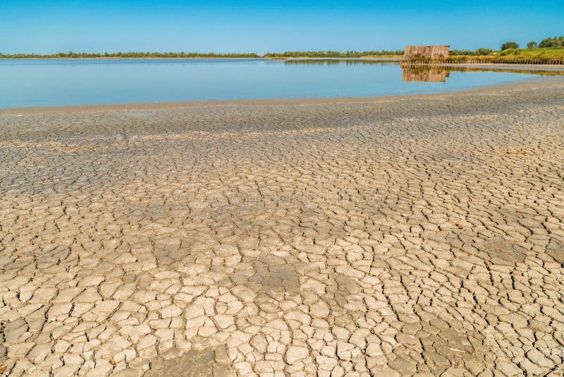 Cracked clay soil beach stock photo. Image of italy, arid - 98779588