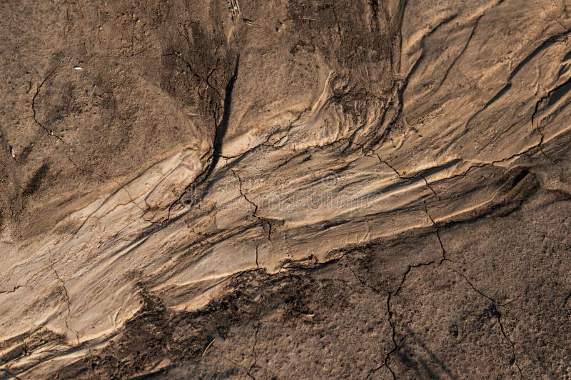 Cracked, Dry Earth with Layered Sedimentary Rock Formations, Displaying ...