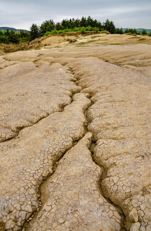 Cracked Ground on Cliff S Edge with Distant Forest Stock Image - Image ...