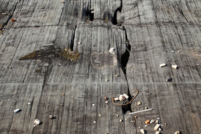 Cracked Rooftop Surface with Scattered Debris and Visible Damage from ...