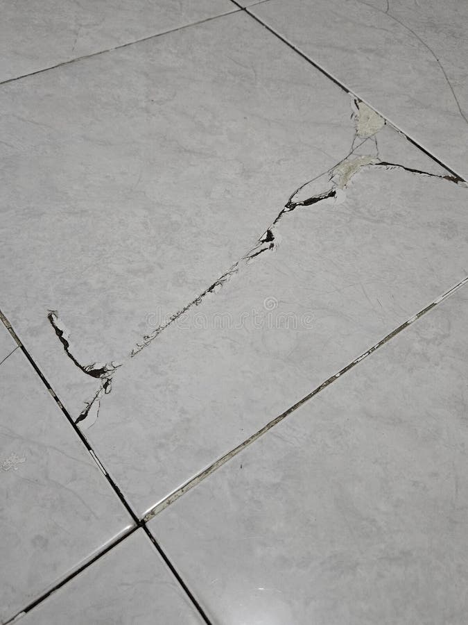 Cracked tile on the floor. stock image. Image of building - 329917999
