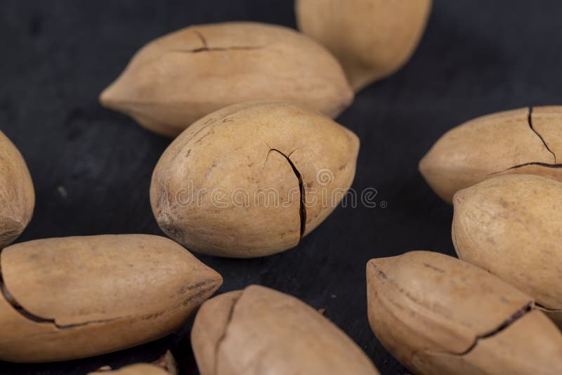 Cracked Unpeeled Pecans Close-up on the Table Stock Photo - Image of ...