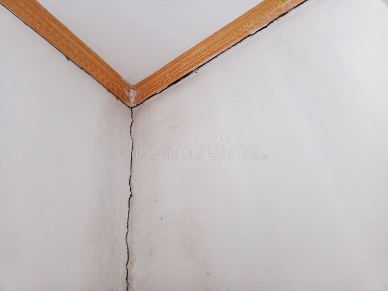 Cracked Wall Corner with Dirty Stains and Ceiling Molding Trim. Stock ...
